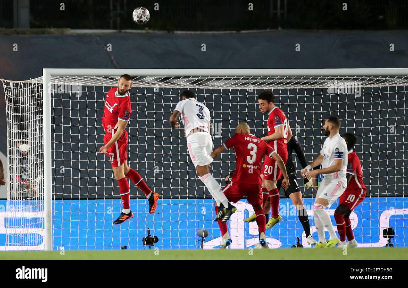 Liverpool's Nathaniel Phillips (left) heads the ball clear during the ...