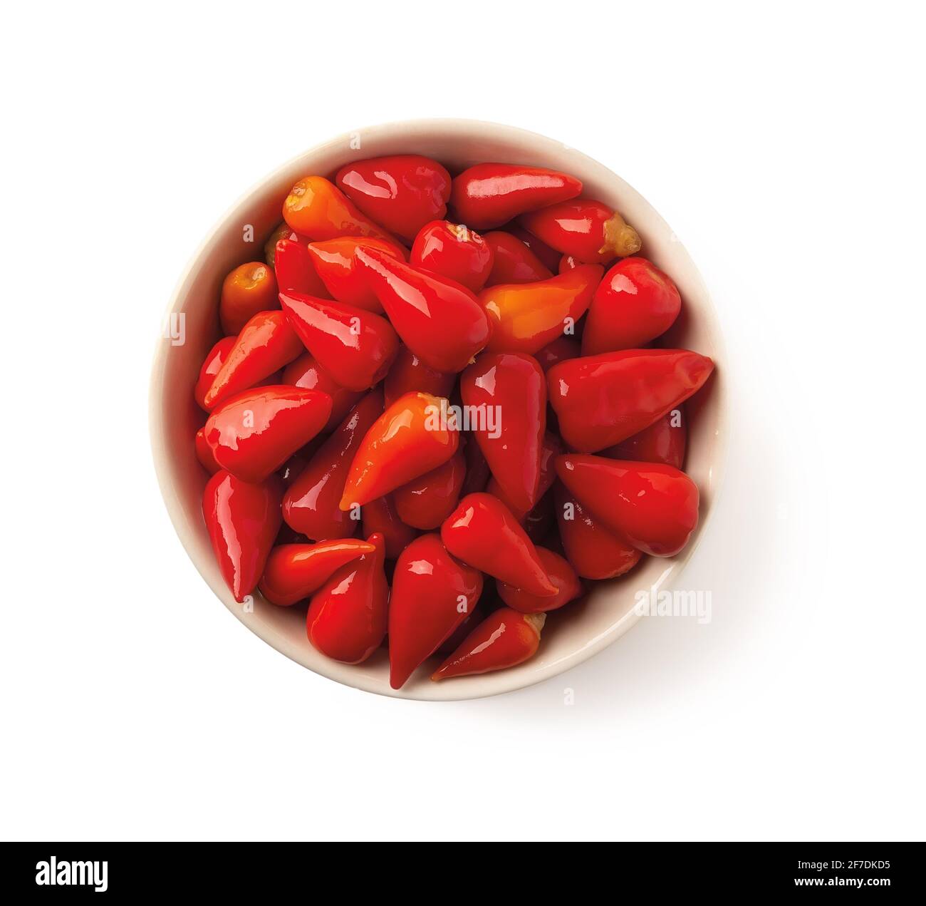 Pickled small red hot peppers in a bowl isolated on white background ...