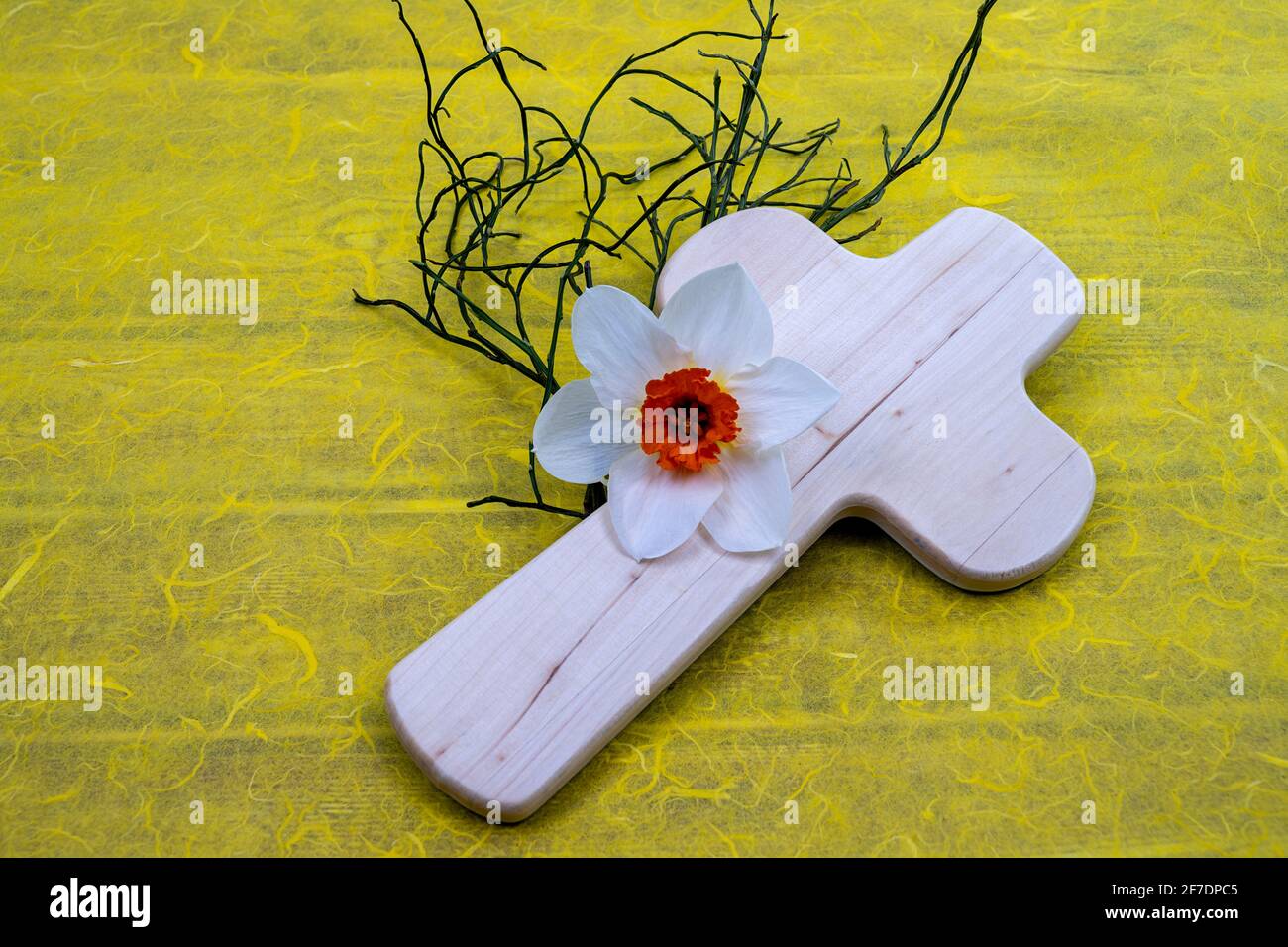 Decoration with the cross of Jesus daffodil and tree branches on the ...