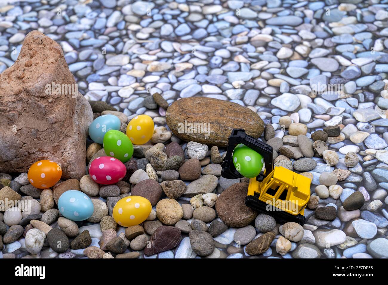 Decoration for Easter, toy excavator with colored eggs and decorative ...