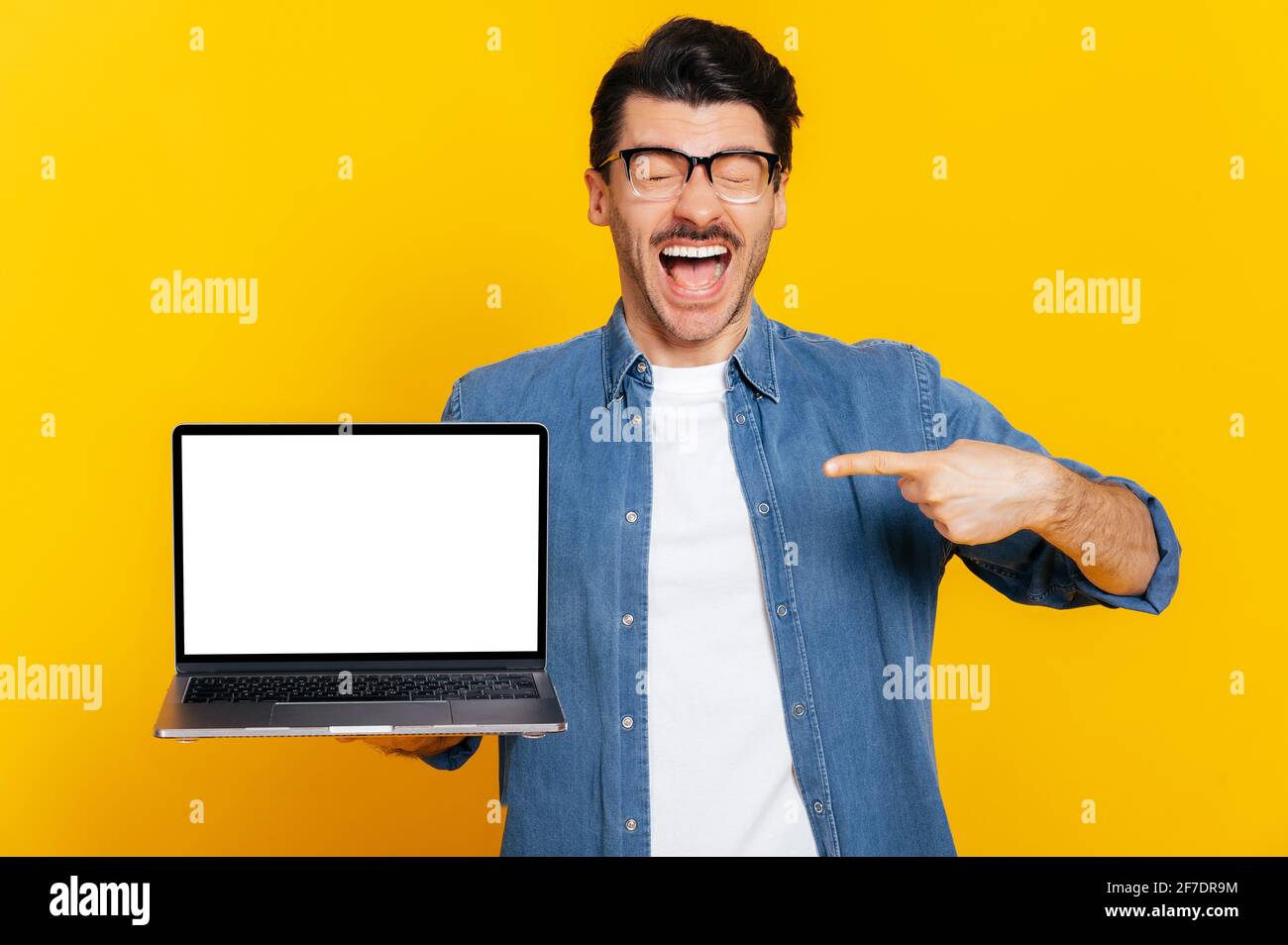 Happy shouting caucasian excited stylish guy with glasses, holds an ...