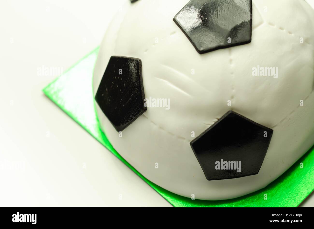 Football cake, sponge filled with frosting and raspberry jam, finished ...