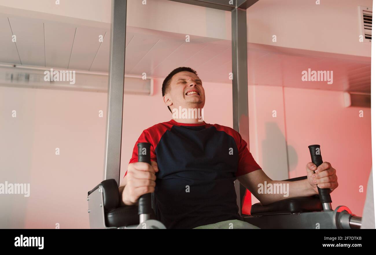 Athlete, fitness club, exercises on the uneven bars, sports equipment ...