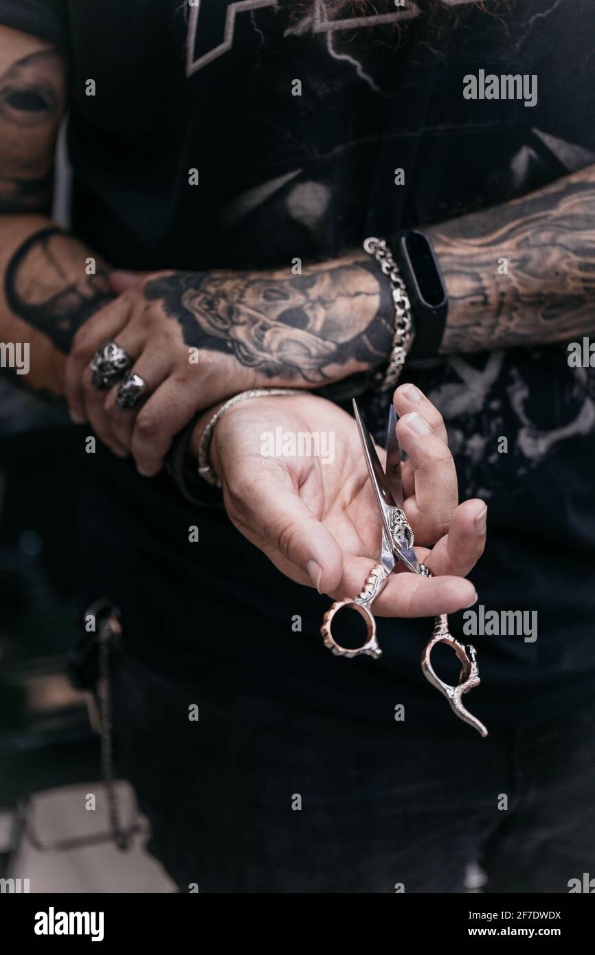 professional barber tool: sharpened scissors held by a haircut master ...