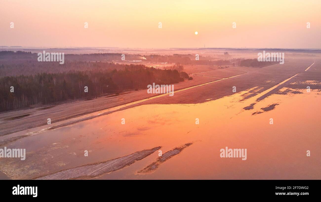 Sunrise spring melting river flood aerial panorama. Overflow water at ...