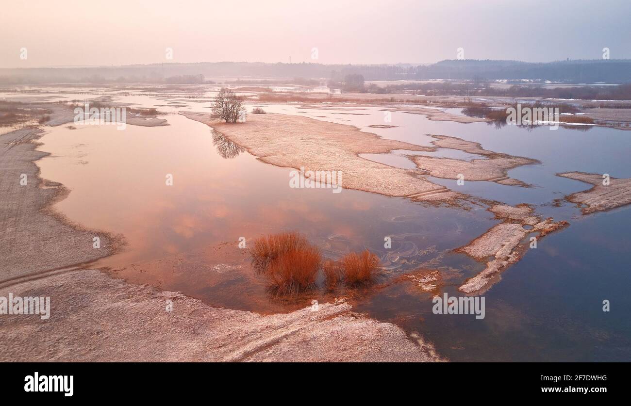 Sunrise spring melting river flood aerial panorama. Overflow water at ...