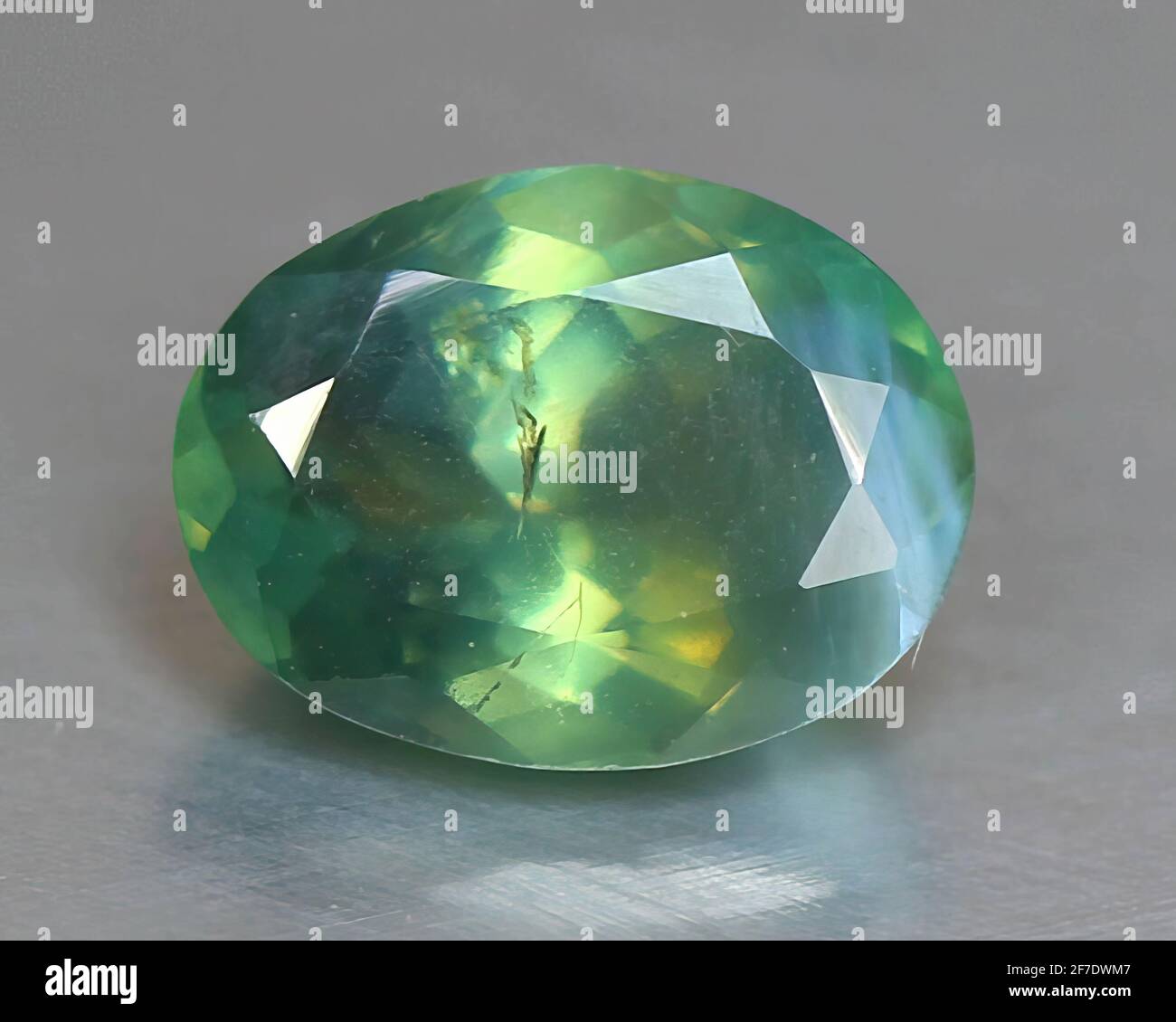 Natural gemstone alexandrite with color change on gray background Stock ...