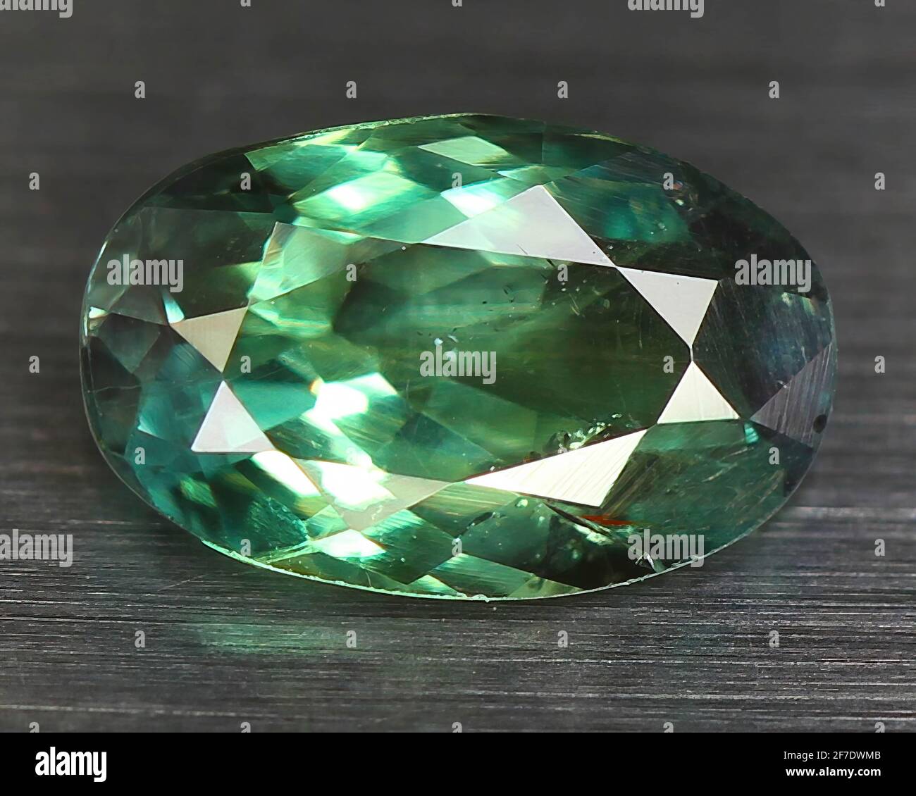 Natural gemstone alexandrite with color change on gray background Stock ...