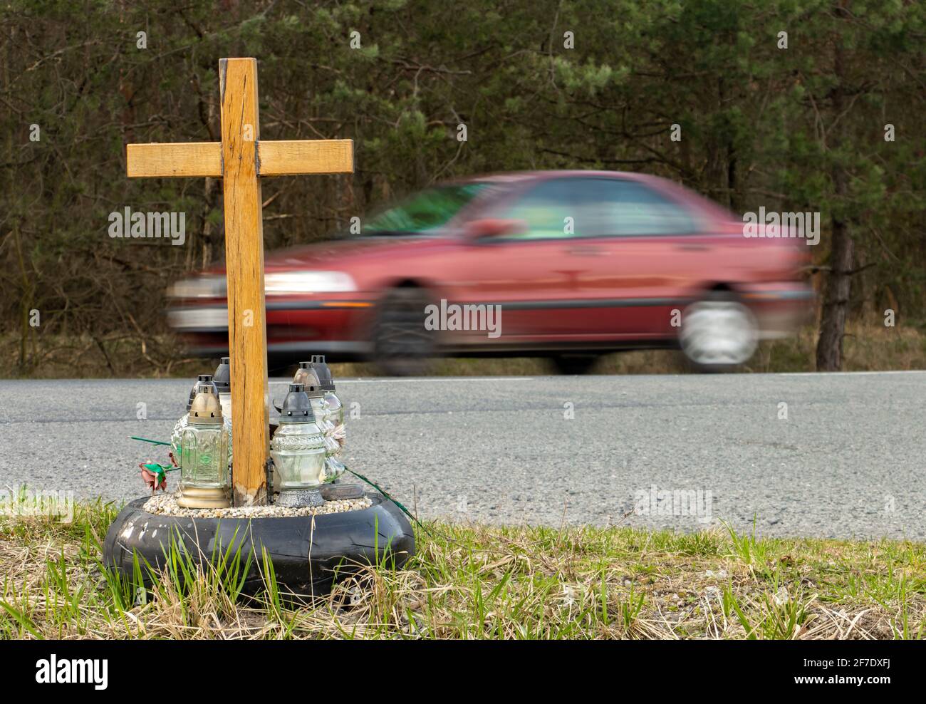A roadside memorial cross with a candles commemorating the tragic death ...