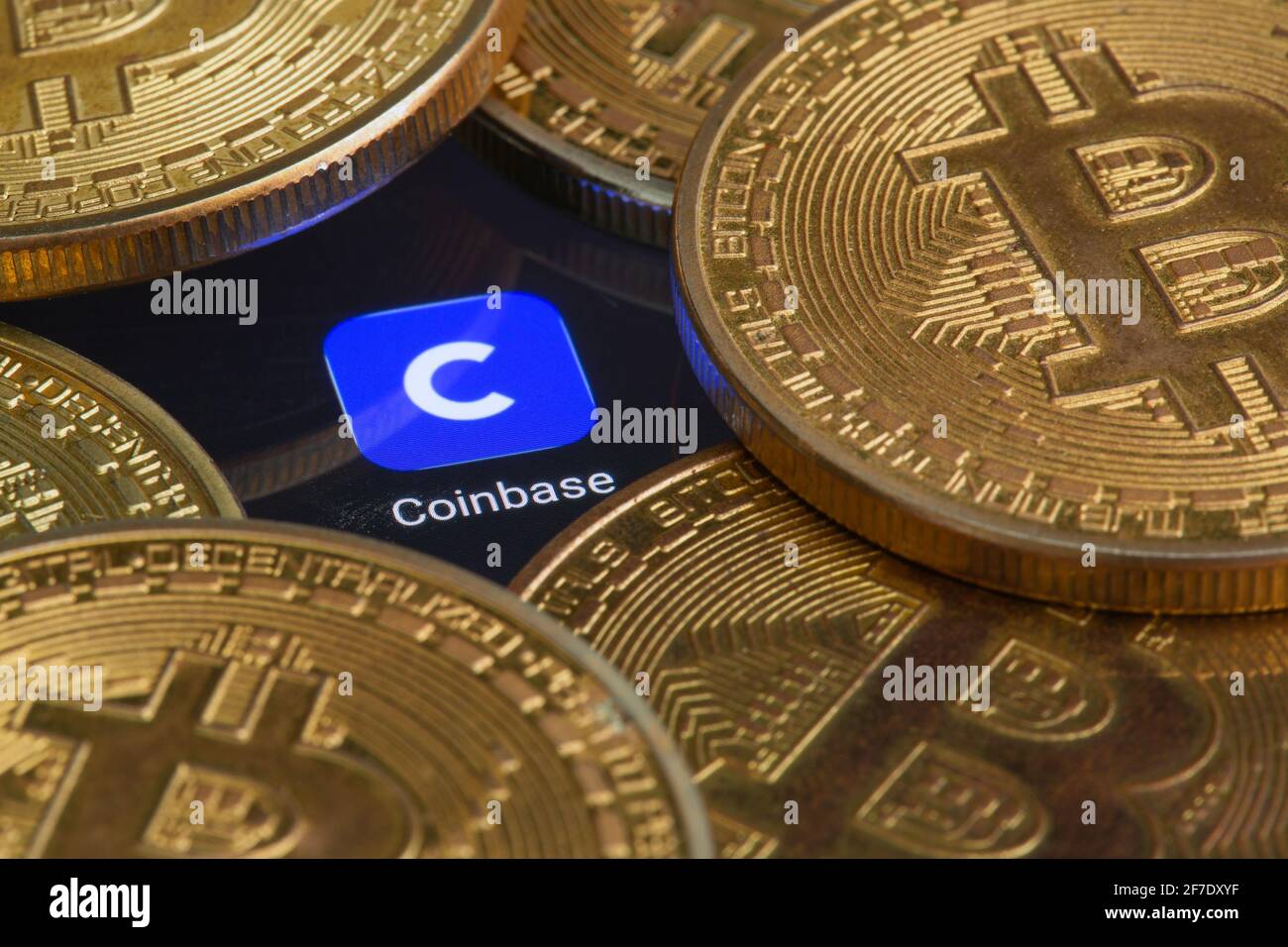 Coinbase logo on screen with Bitcoin coins. Ljubljana, Slovenia - April ...