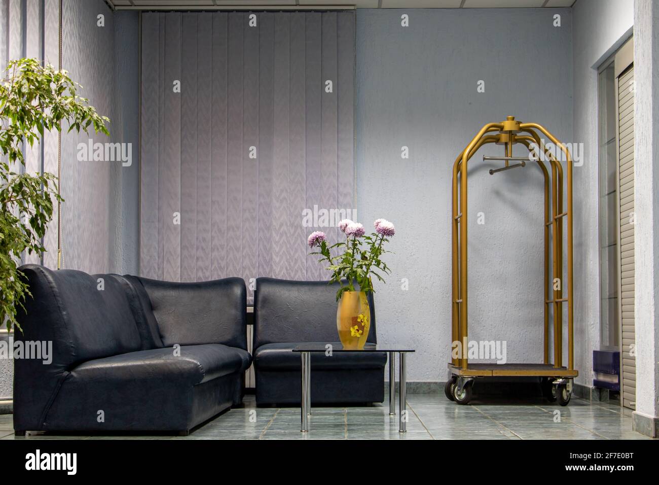 A hotel interior with seating area and luggage trolley Stock Photo - Alamy