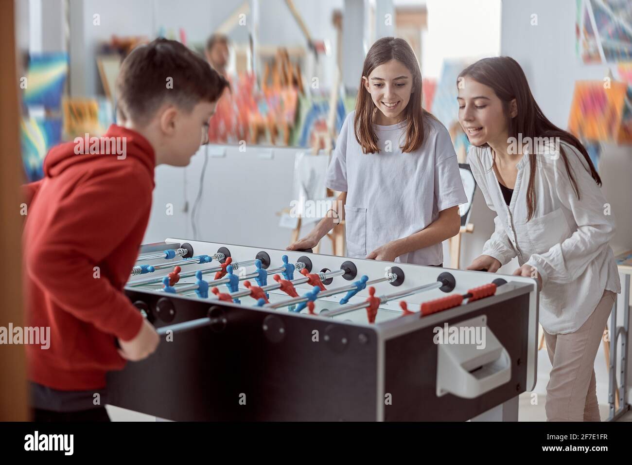 Elementary school kids in a classroom playing table football. Fun while ...