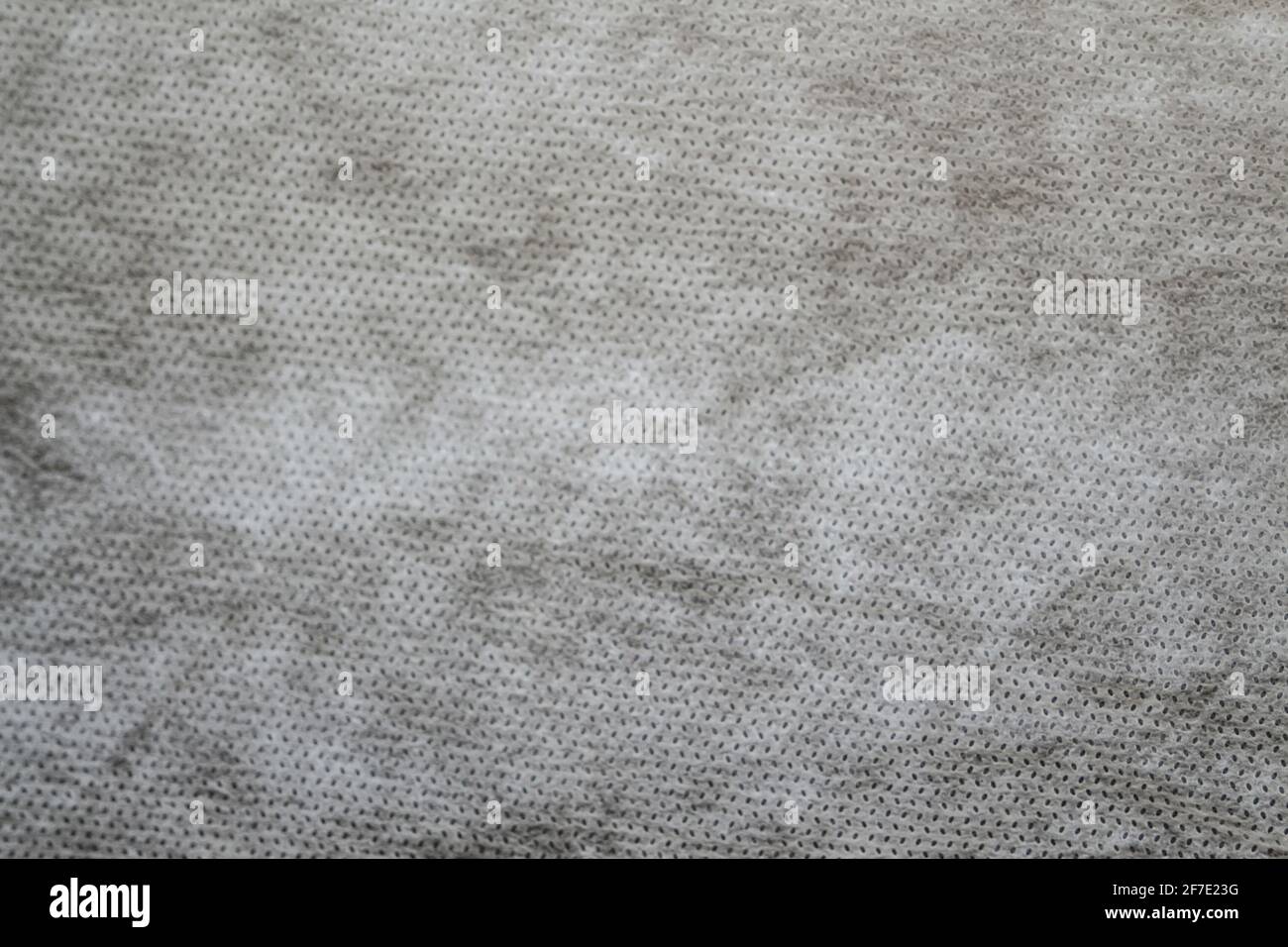 Defocus grey spunbond non-woven geotextile close-up macro. Small spots ...