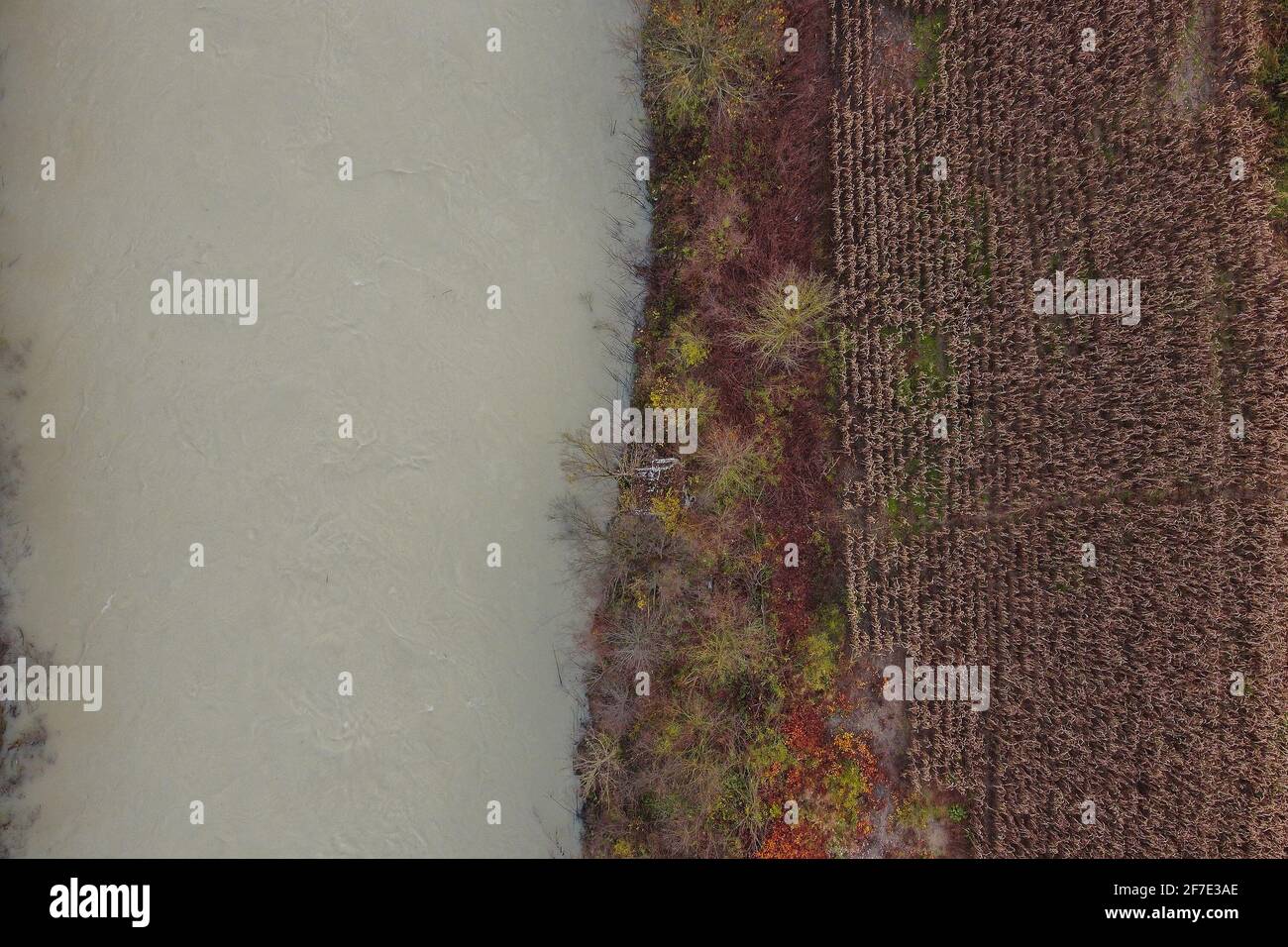 Aerial view of white murky river and fields next to it. Upside down ...