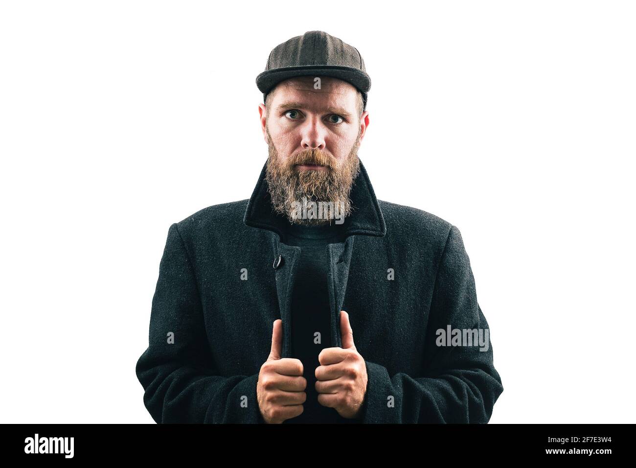 Angry looking hipster man with a beard and a baseball hat wearing a ...