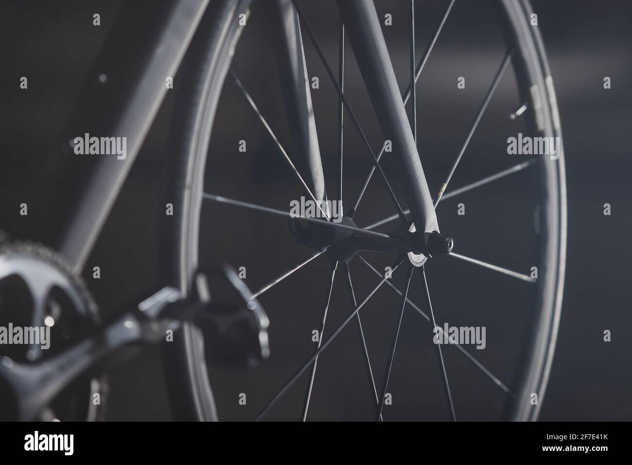 Detail of the front part of a road bicycle on a silky black background ...