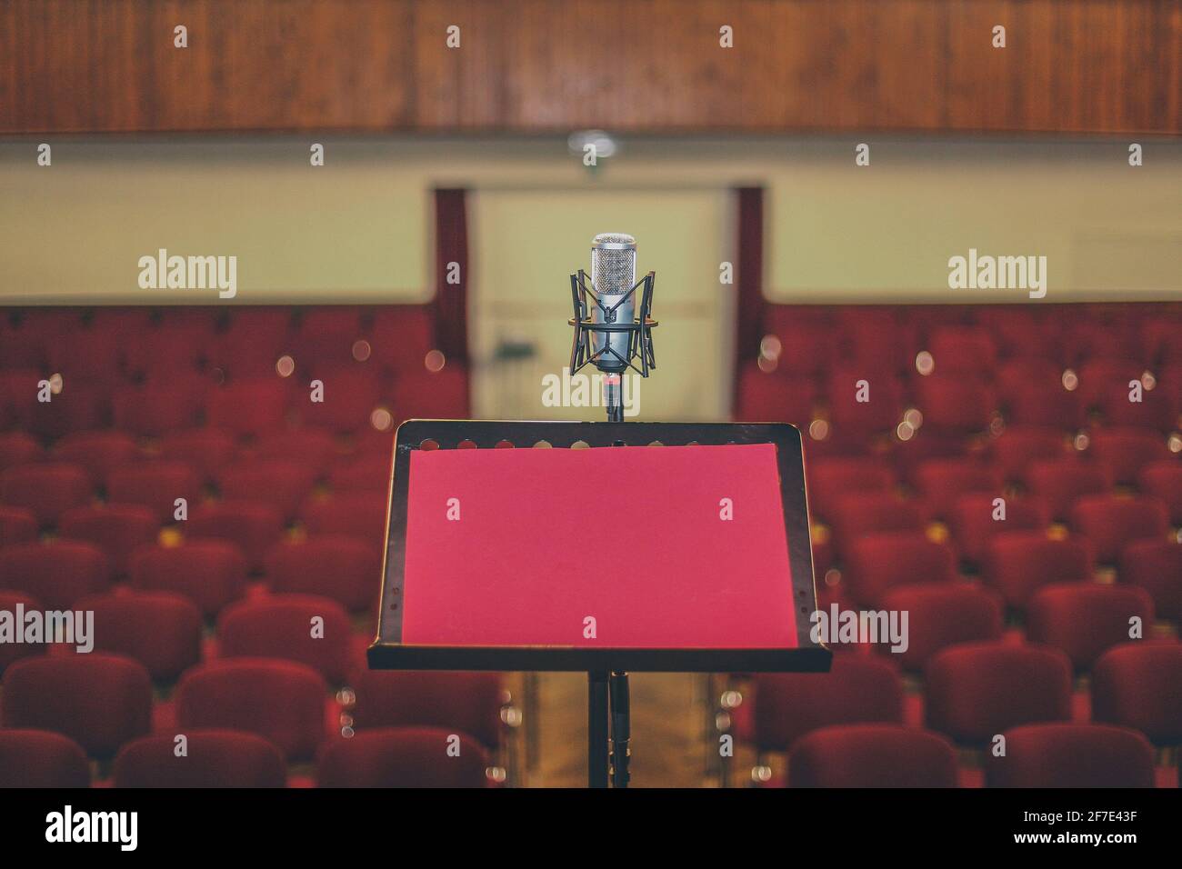 Music or note stand and an old vintage microphone in a small theatre ...
