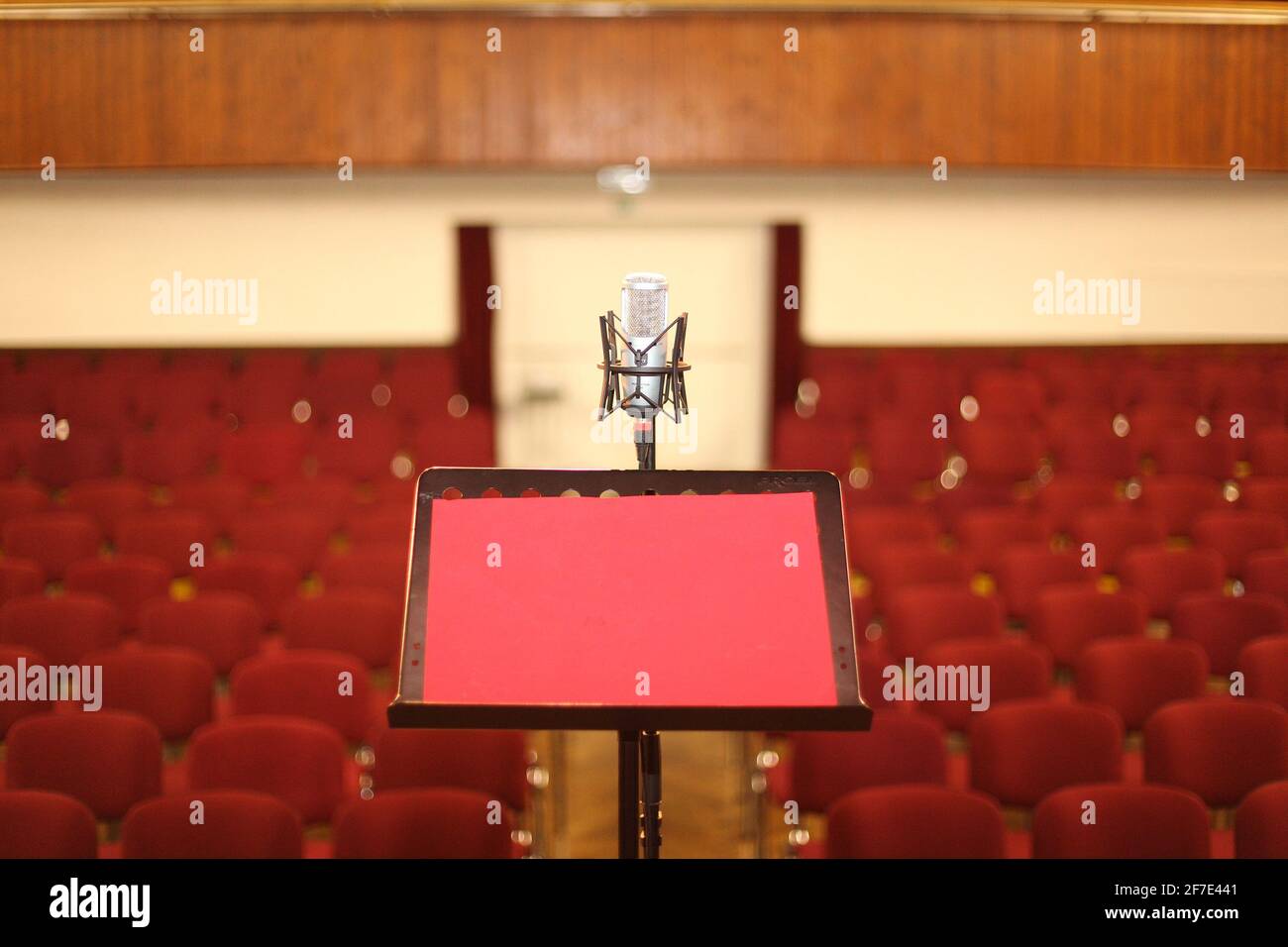 Music or note stand and an old vintage microphone in a small theatre ...