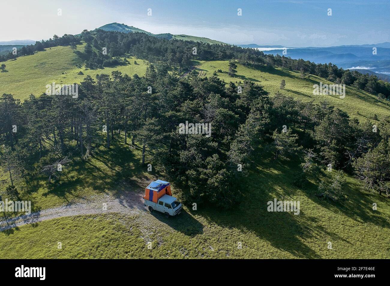 Aerial photo of a van with a tent on the back on the top of the ...