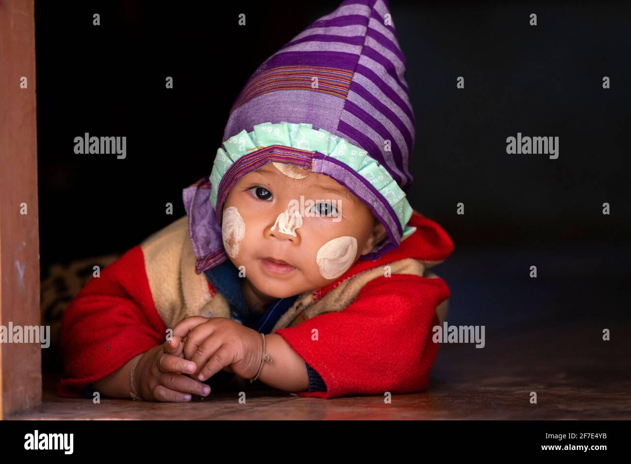 Cute Burmese boy with hat crawling on floor, Loikaw, Myanmar Stock ...