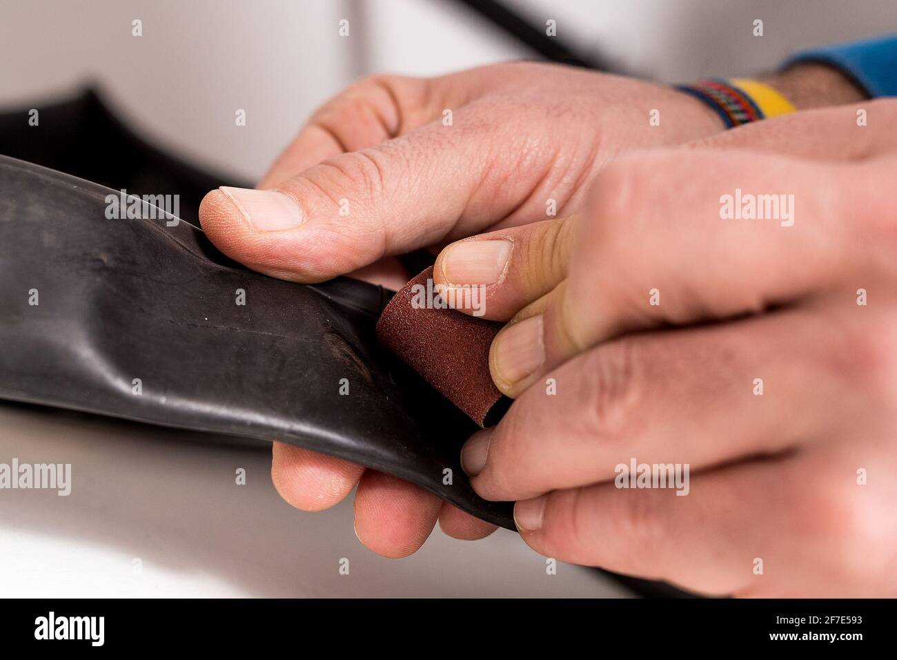 Bicycle inner tube repair. A person is sanding an inner tube before ...