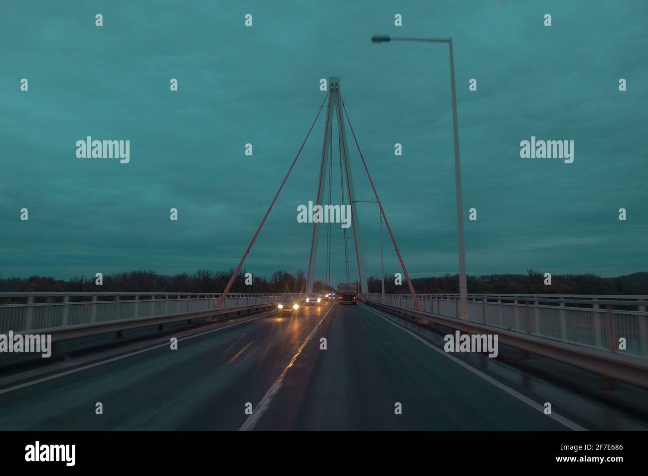 Cloudy and rainy atmosphere on a concrete suspension bridge Stock Photo ...