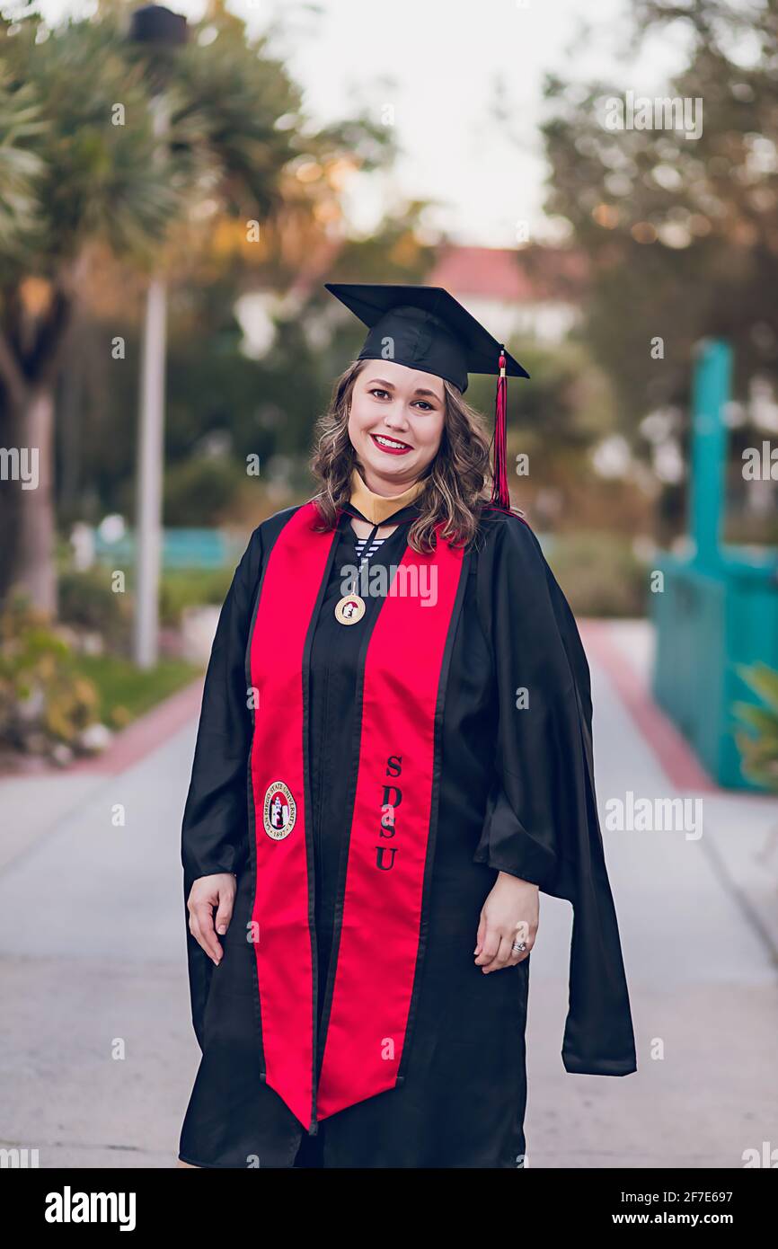 Young woman graduating college, wearing a graduation gown/cap Stock ...