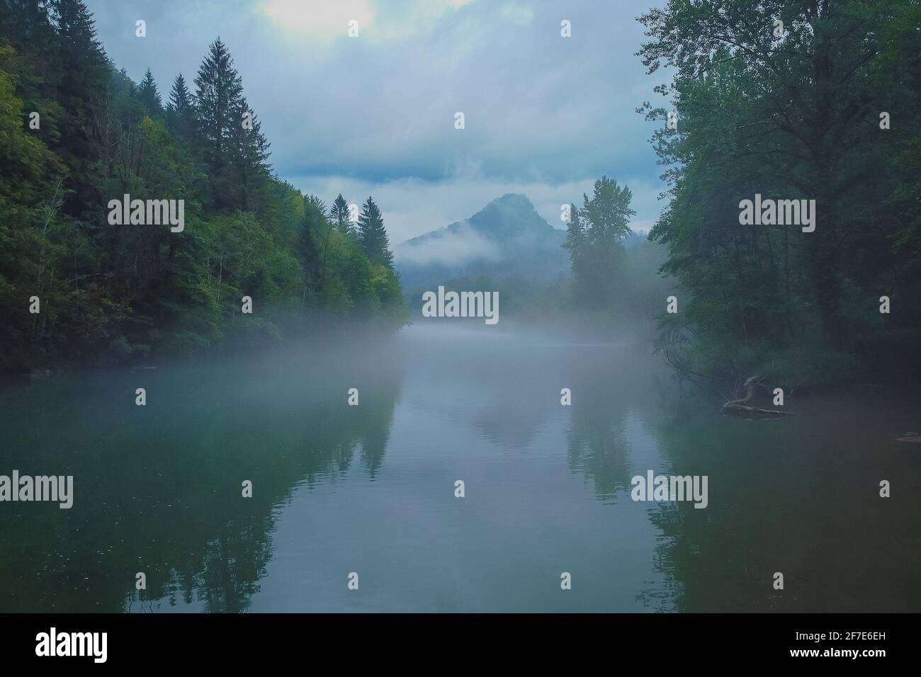 Scary spooky river of Kolpa on a gray dull summer day with clouds and ...