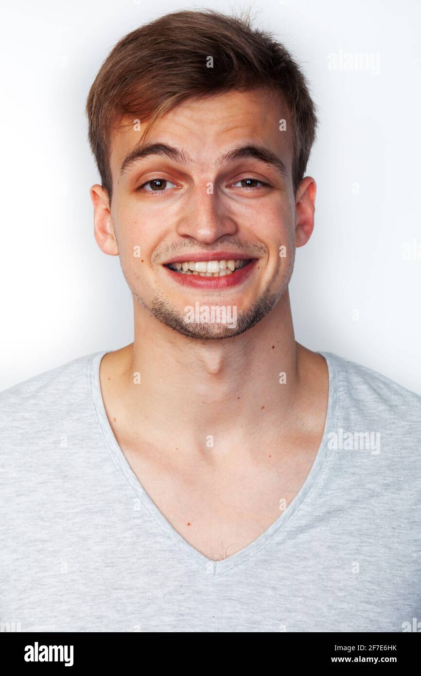 young handsome teenage hipster guy posing emotional, happy smiling ...