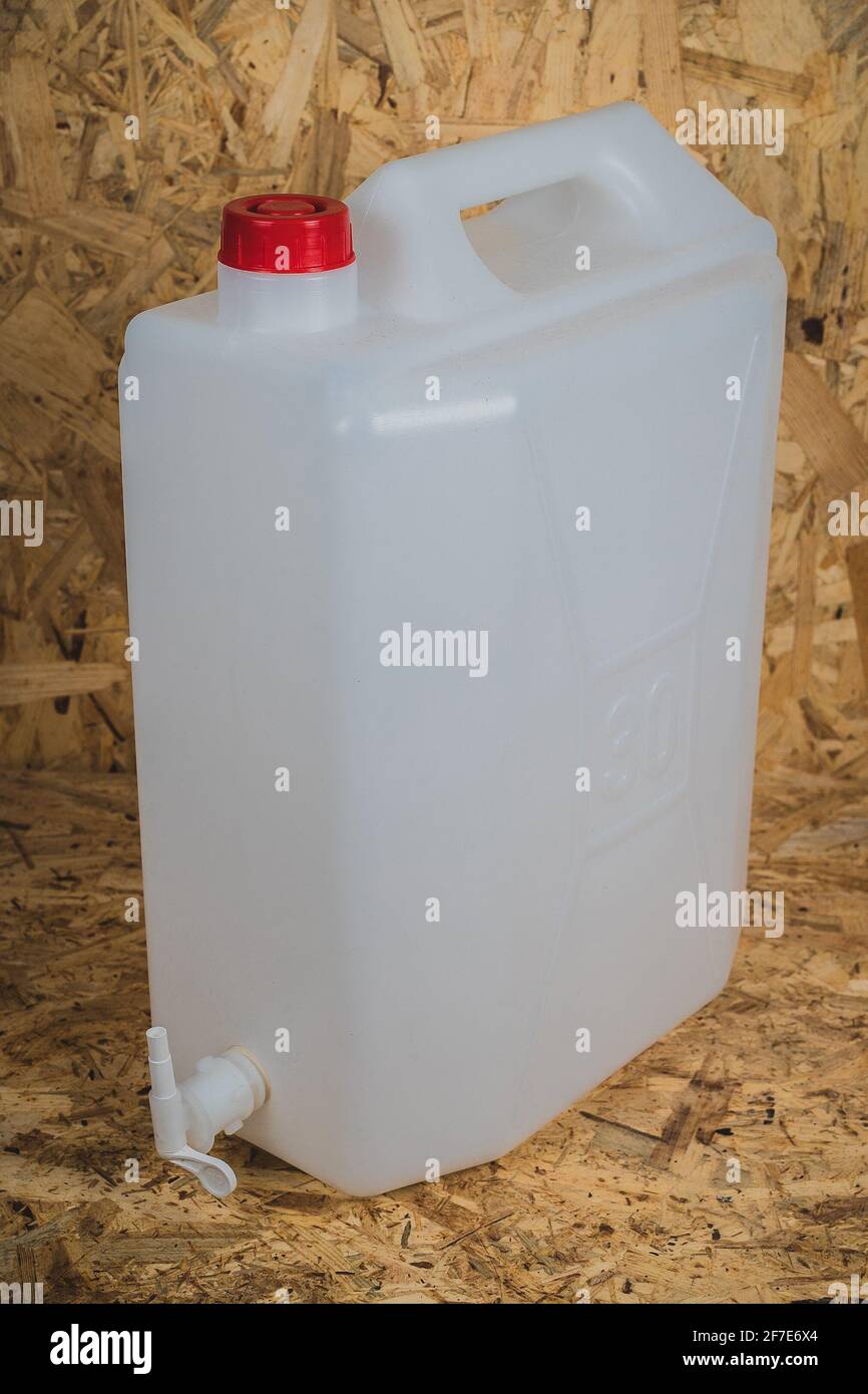 Side view of white plastic transparent jerry can for water with a ...