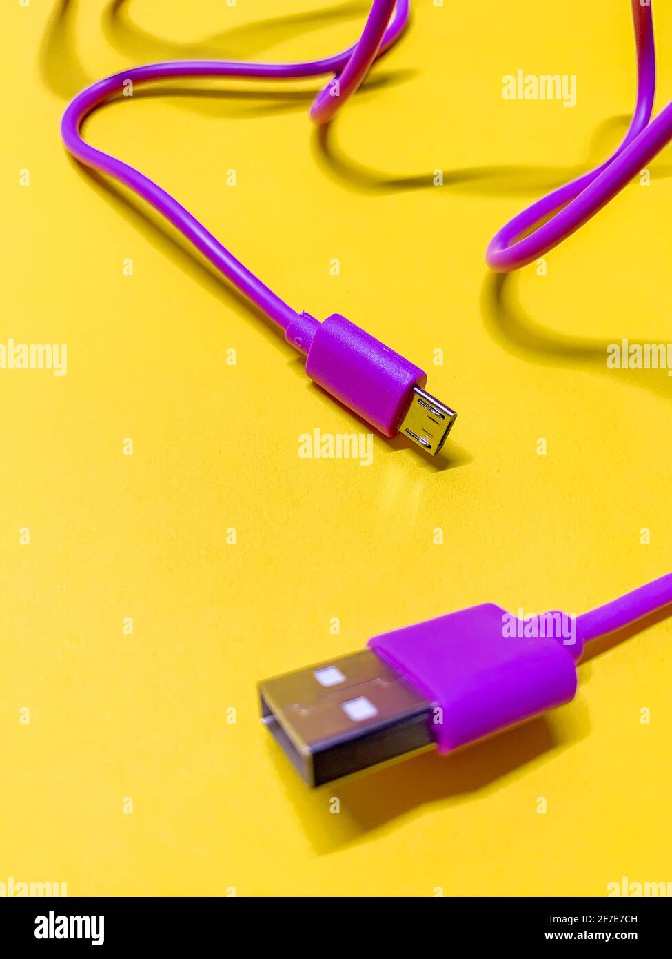 purple usb cord on bright yellow background vertical orientation Stock ...