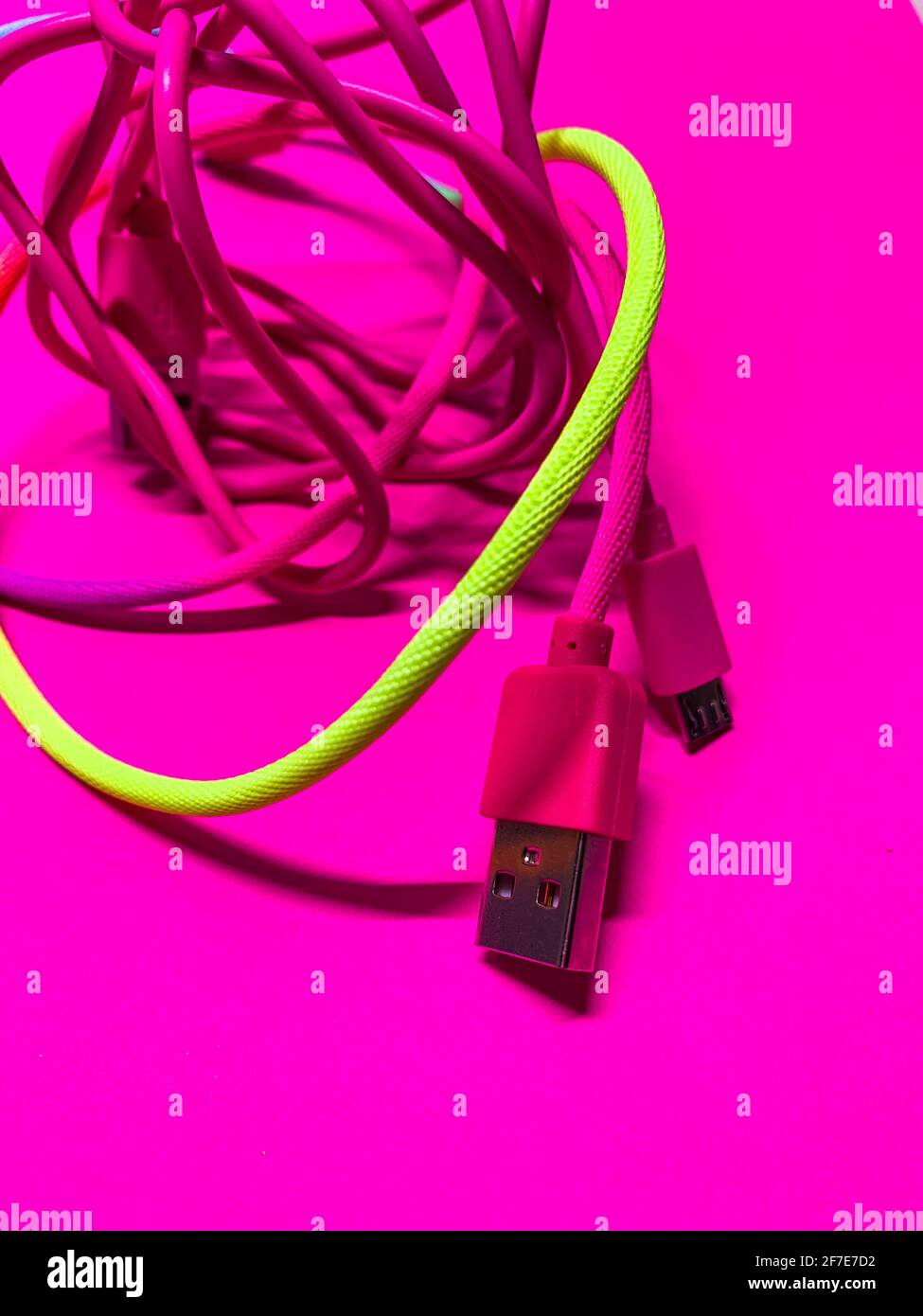 tangled usb cords neon pink and lime vertical layout Stock Photo - Alamy