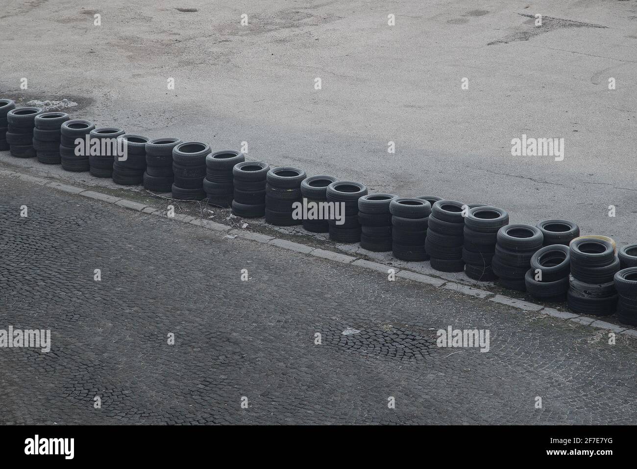 A fence or barrier made of old used rubber car or automotive tires or ...