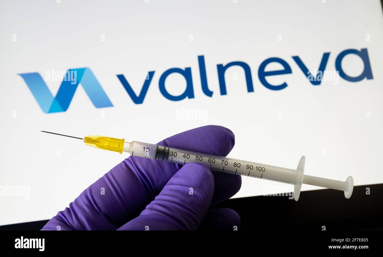 Valneva COVID-19 vaccine concept. Syringe and Valneva company logo on ...