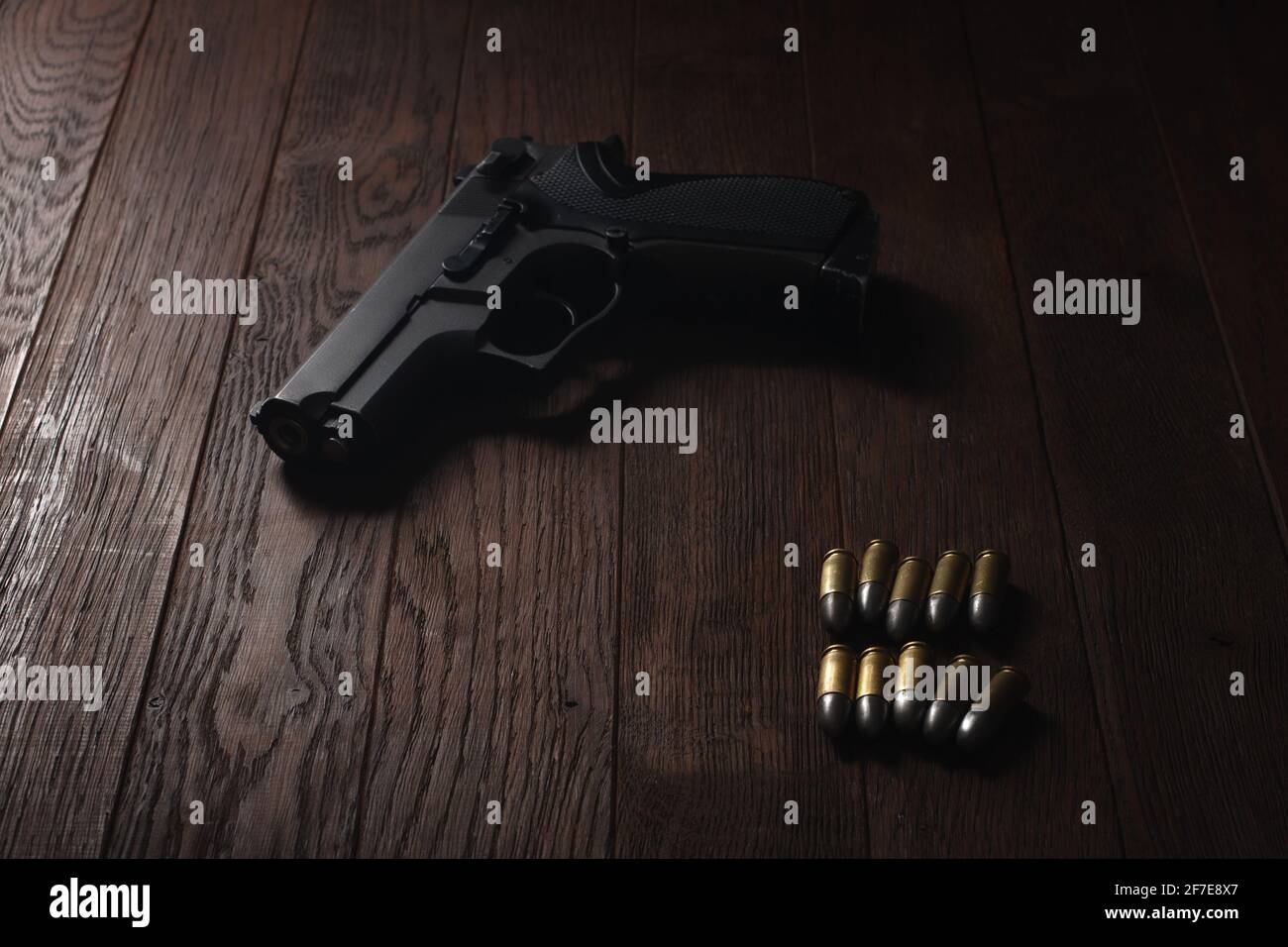 semi-auto handgun with cartridges on wooden table Stock Photo - Alamy