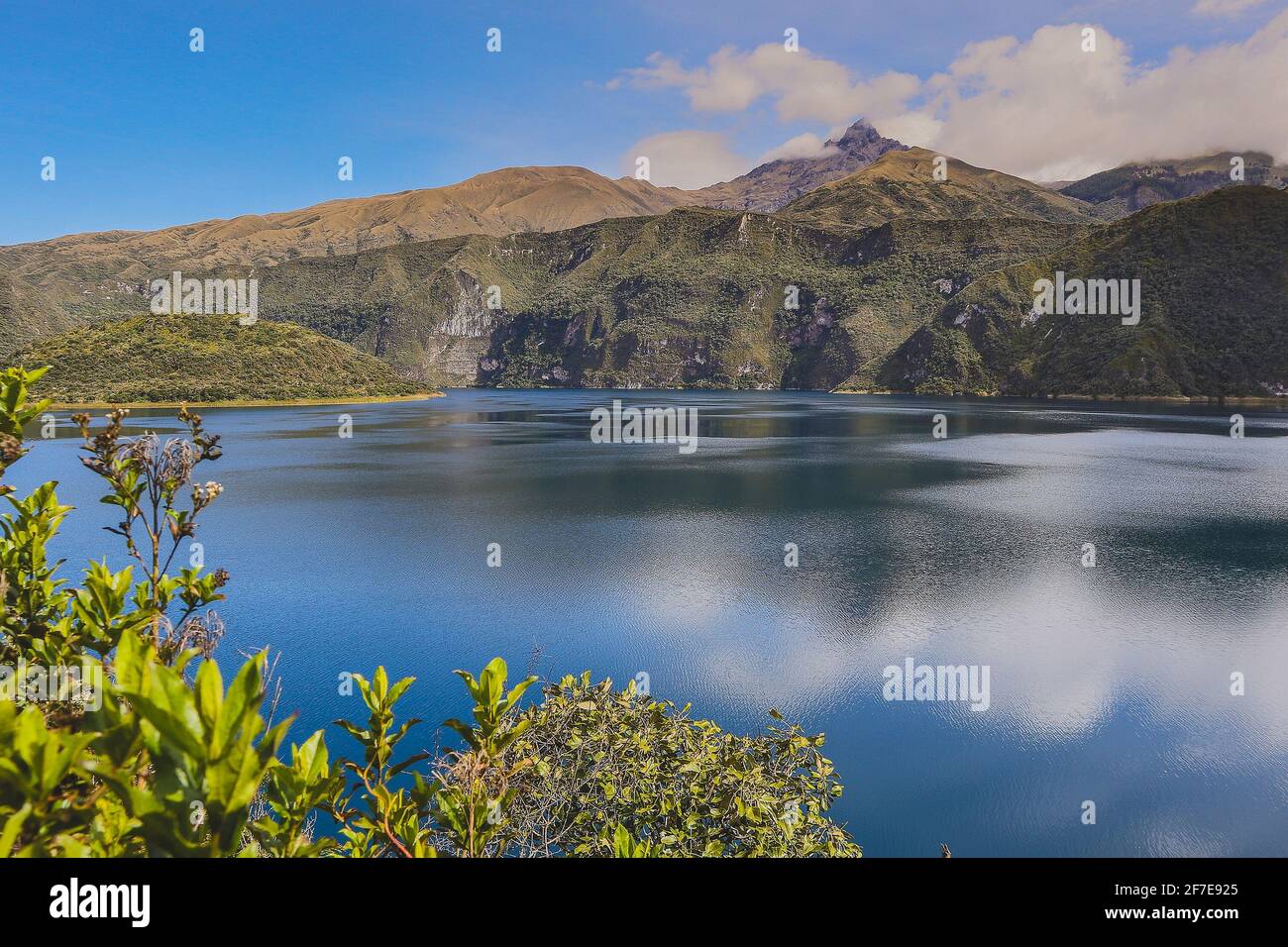 Mountains in Ecuador overlooking a blue lake, surrounded with lush ...