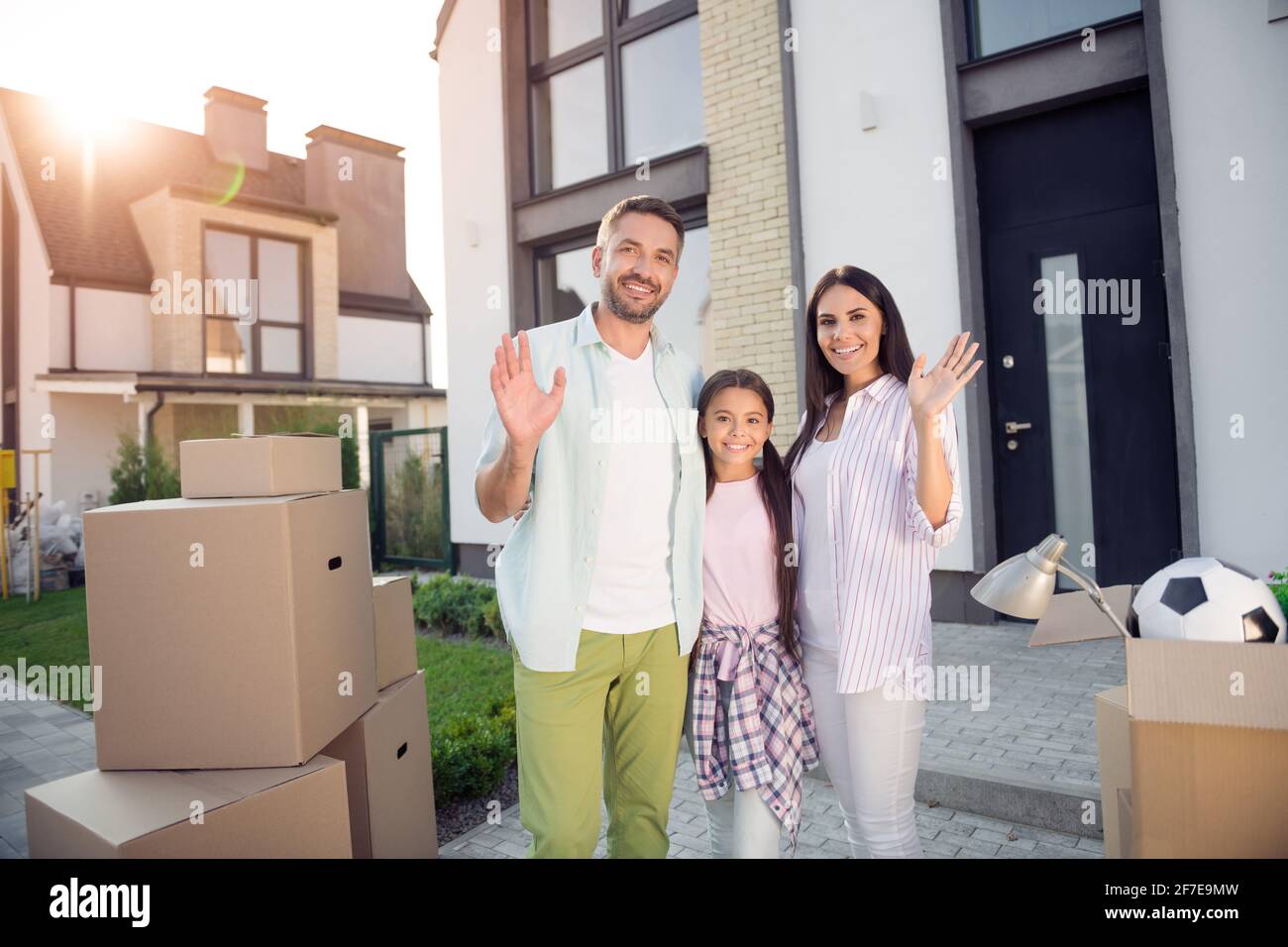 Photo of optimistic family wave hand remove with boxes wear casual ...