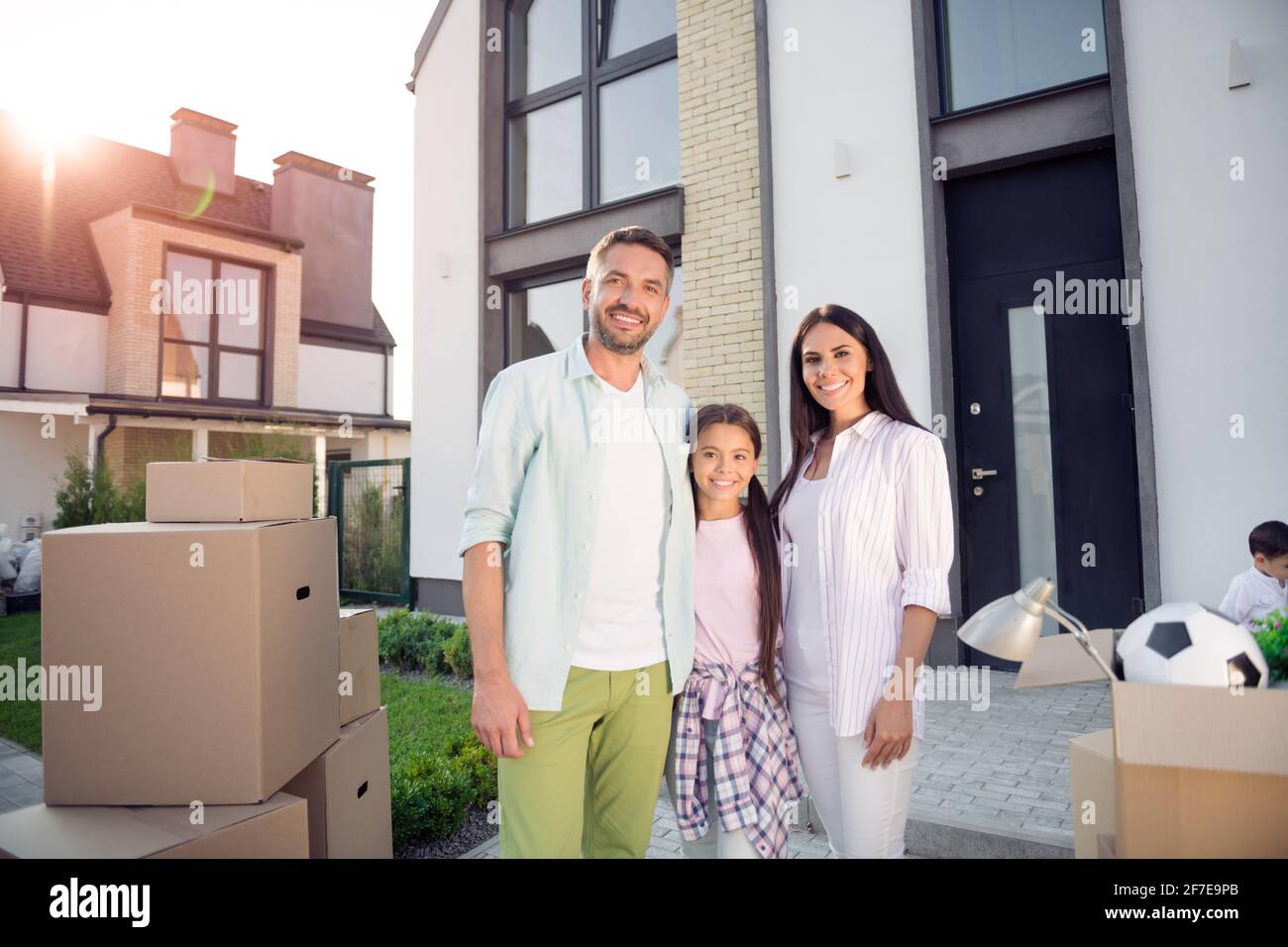 Photo of happy cheerful smiling family move to new house relocate stuff ...