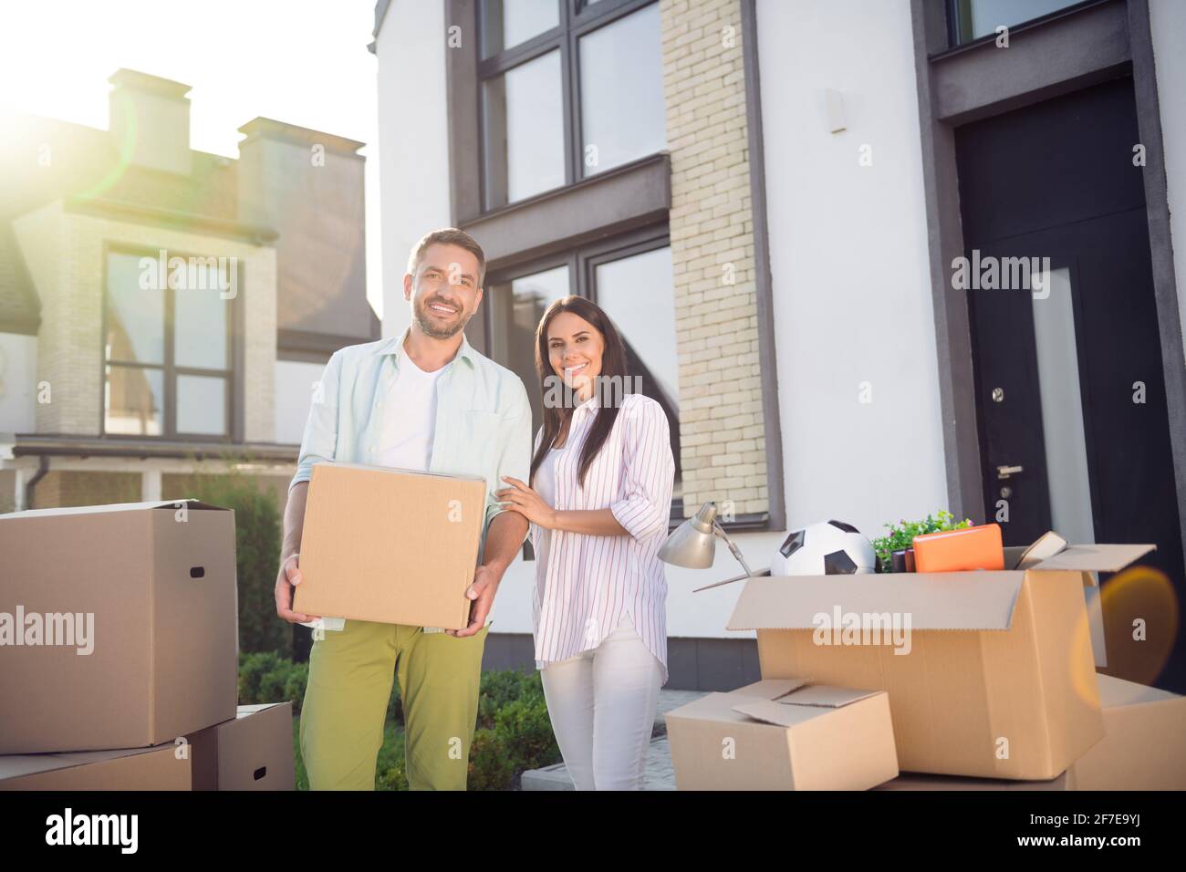 Photo of optimistic couple remove with boxes wear casual cloth near ...