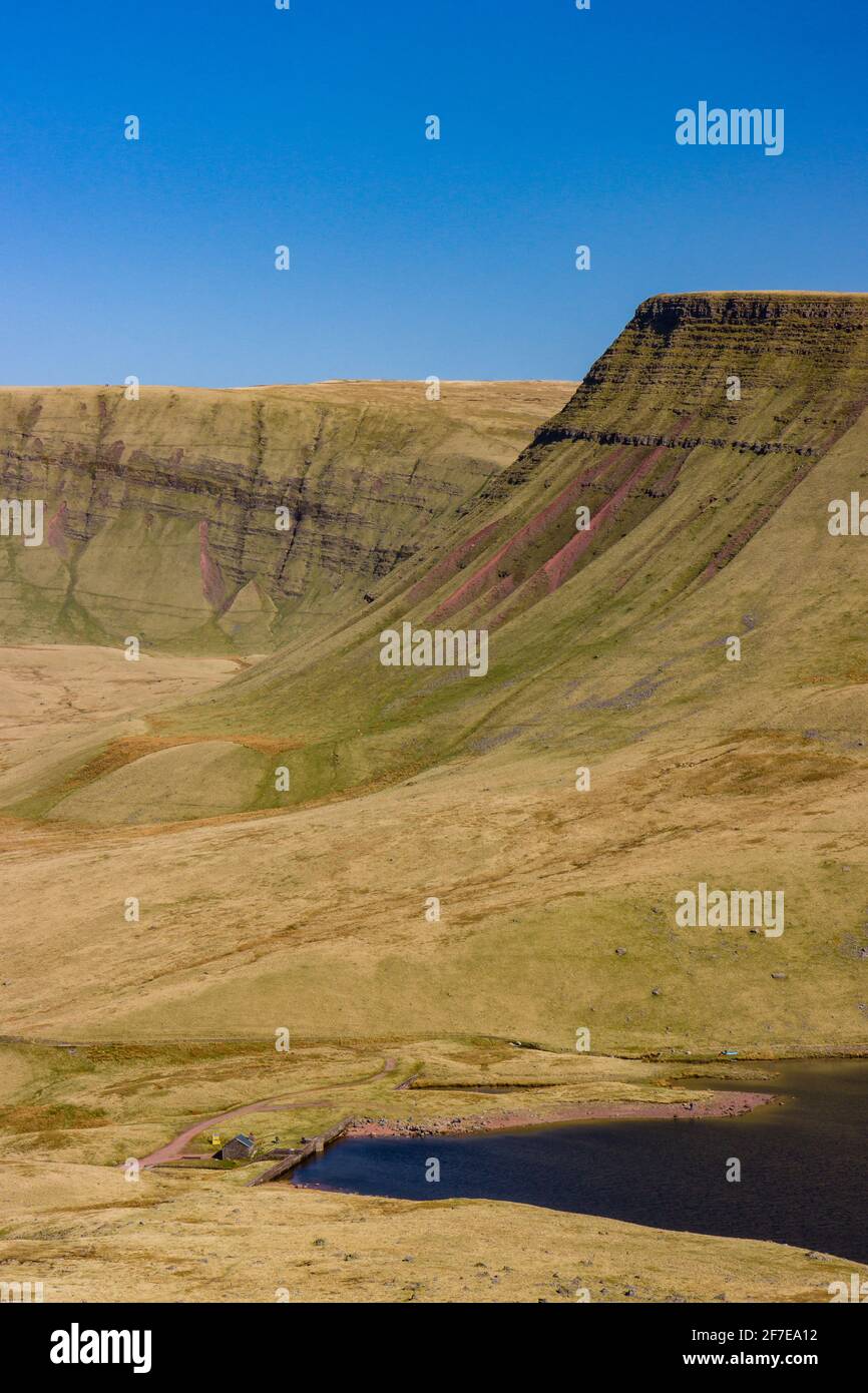 A beautiful lake at the foot of steep-sided mountains (Llyn y Fan Fach ...
