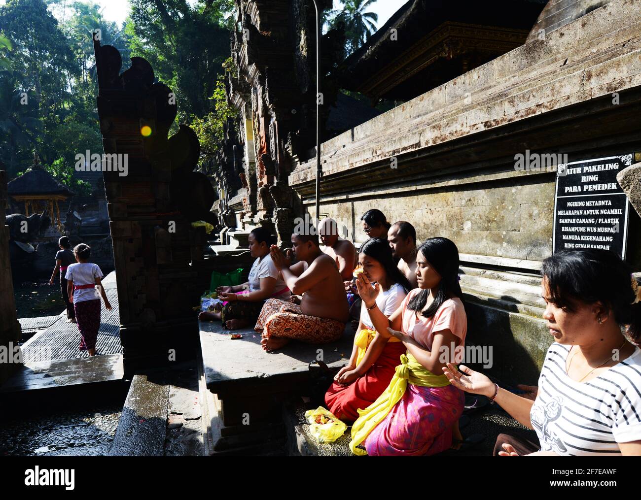 Morning prayers at the purifying pool at the Tirta Empul temple in Bali ...