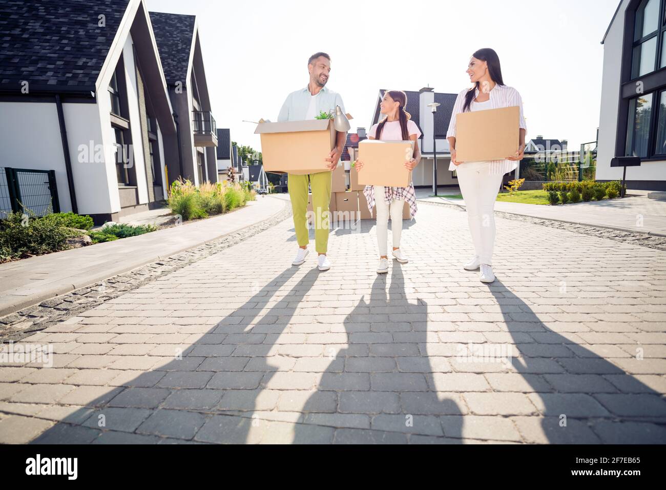 Full length body size view of three cheery family walking carrying ...