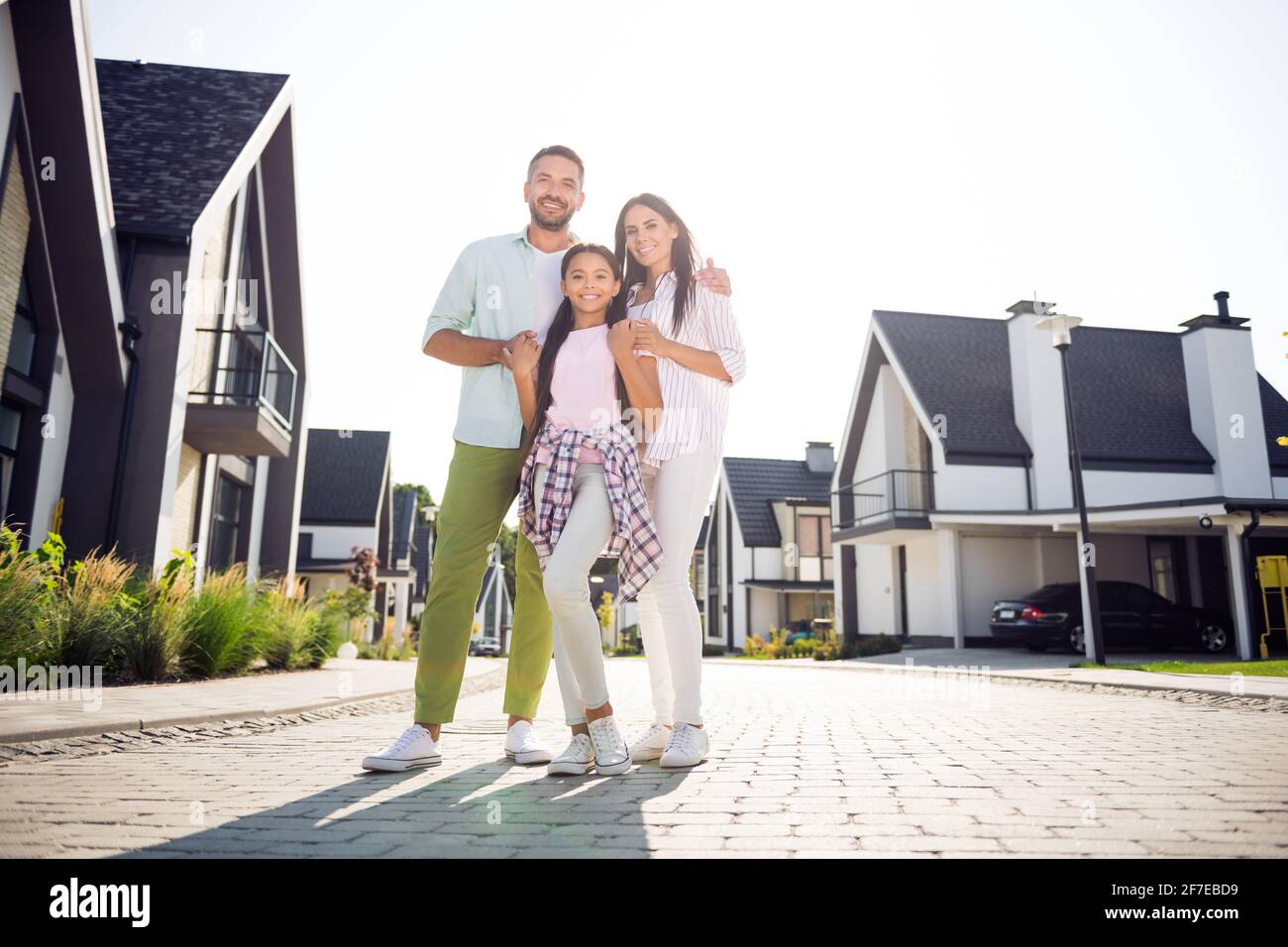 Full length photo of friendly positive family stand together hug have ...
