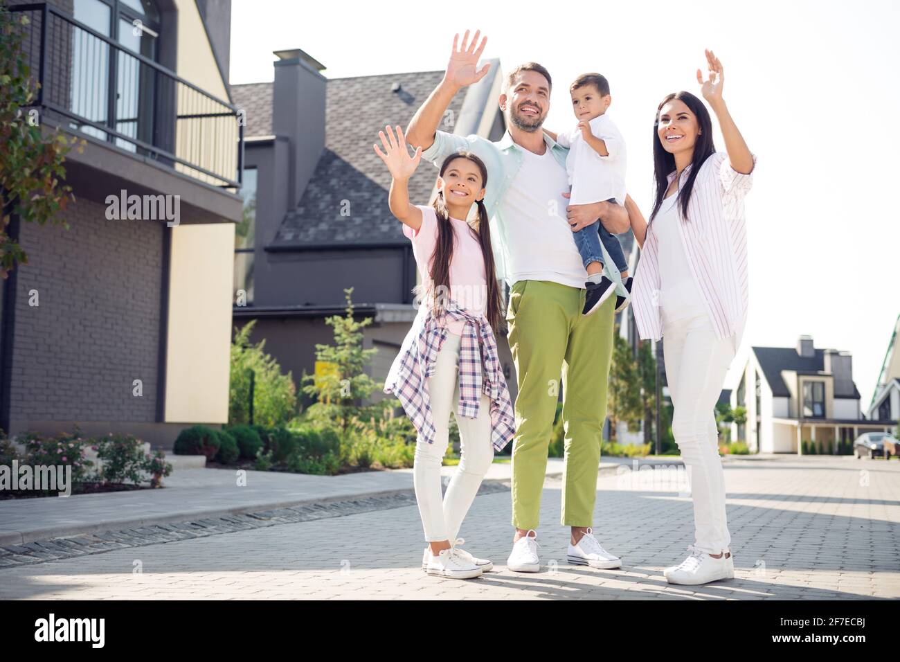 Full size photo of young happy positive smiling family waving hands ...