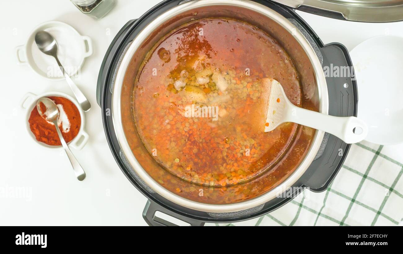Cooking using modern electric multi cooker. Lentil soup recipe Stock ...
