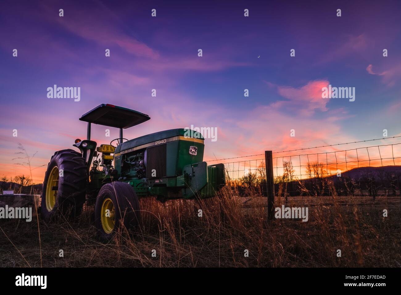 Tractor And Barn With Sunset