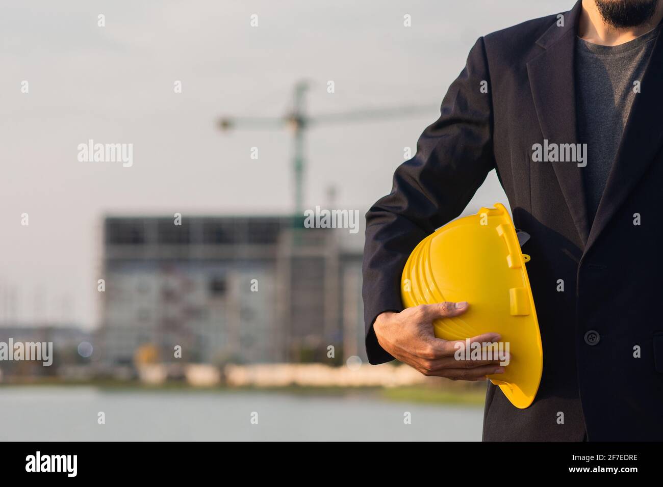 Technician holding yellow hat safety hard hat sunlight background Stock ...