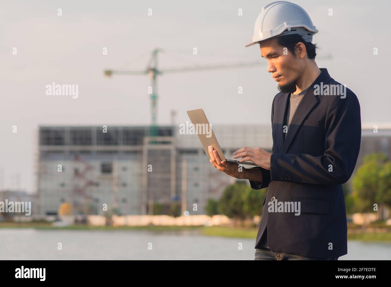 Asian man designer work outdoor in area site construction factory plant ...