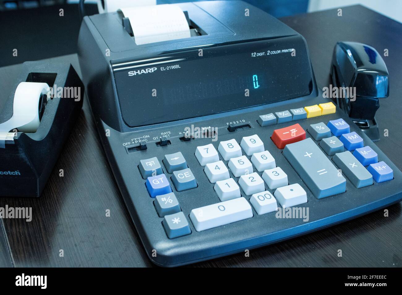 Office calculator, stapler, and tape on desk Stock Photo - Alamy
