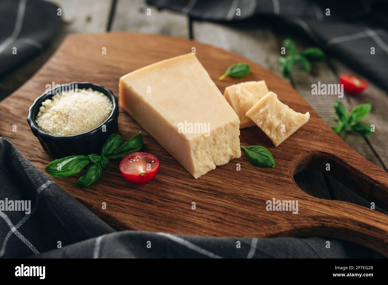 Italian cuisine concept. Cutting board, Parmesan Cheese chunks, grated ...